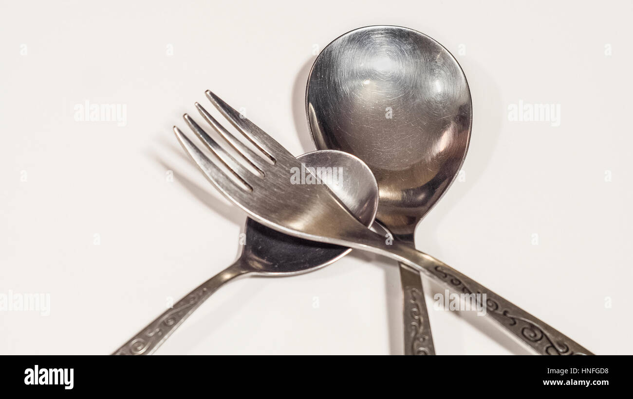 Two spoons and fork on a isolated white background Stock Photo - Alamy