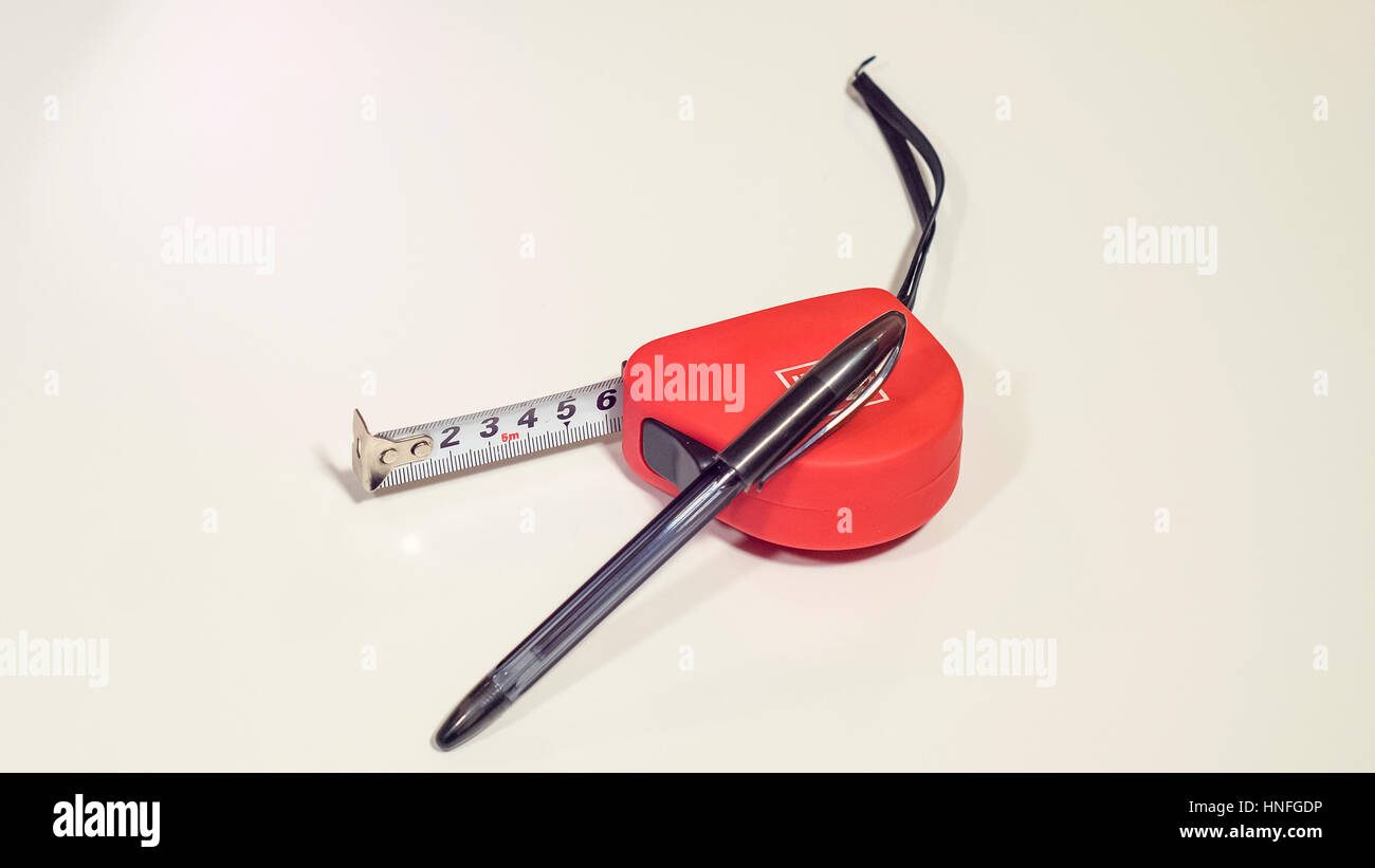 The red tape-measure and the ballpoint pen Stock Photo - Alamy