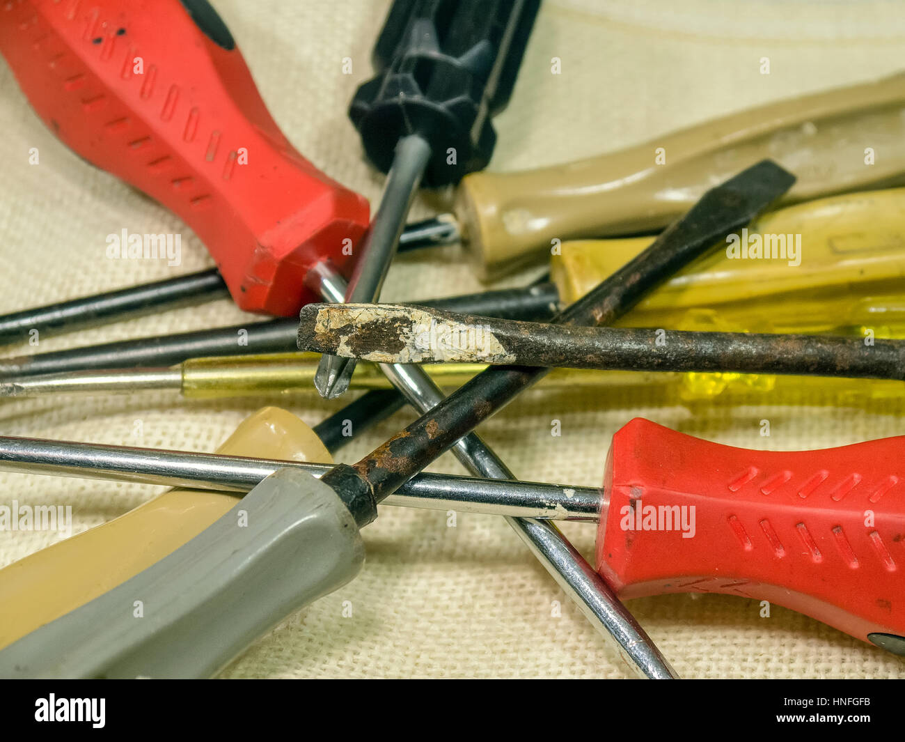 Old stained colorful screwdriver on the bag closeup Stock Photo - Alamy