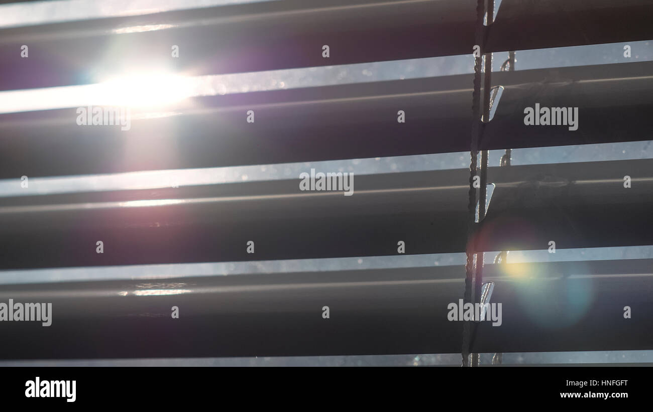 The sun is beautiful shining through the blinds Stock Photo - Alamy