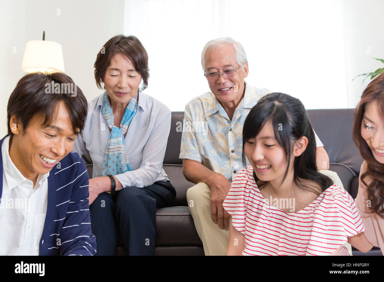 Family member enjoying conversation Stock Photo - Alamy