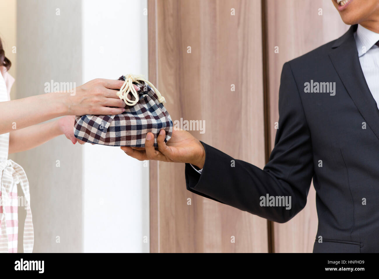 Mother giving a lunch box Stock Photo - Alamy
