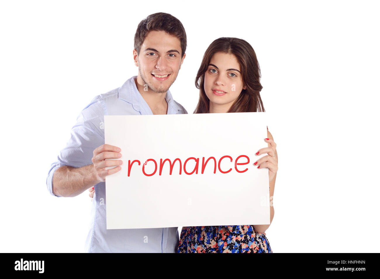 Portrait of a young beautiful couple holding cardboard with word ...