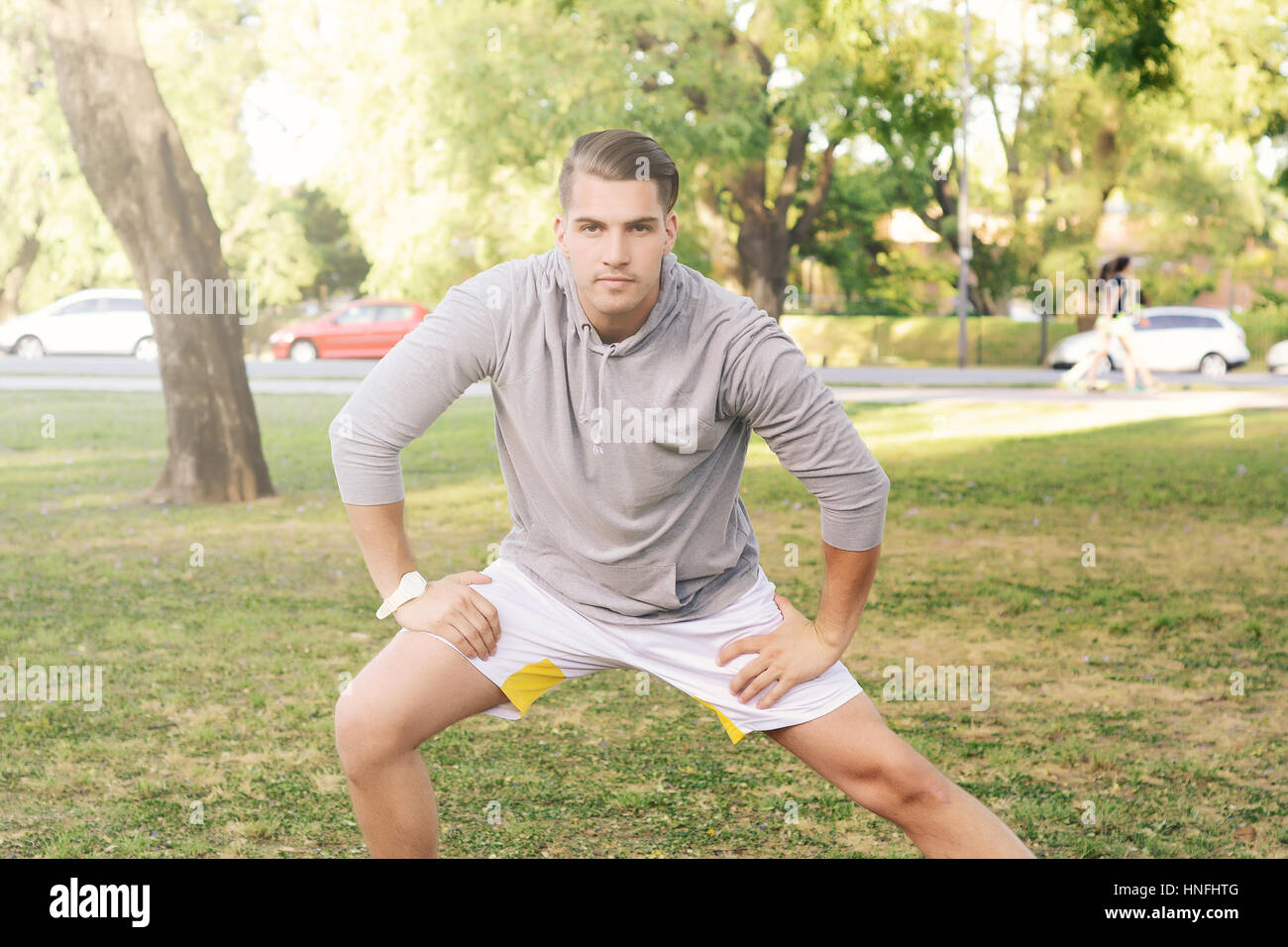 Portrait of a young handsome man doing exercises at the park. healthy ...