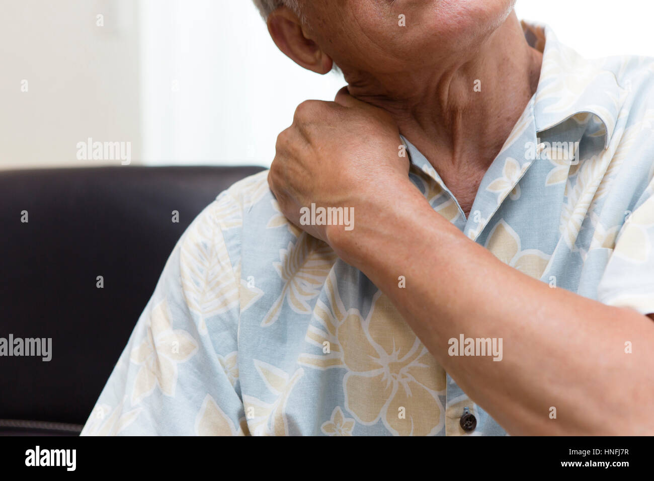 A senior man covering his hand on his shoulder Stock Photo - Alamy