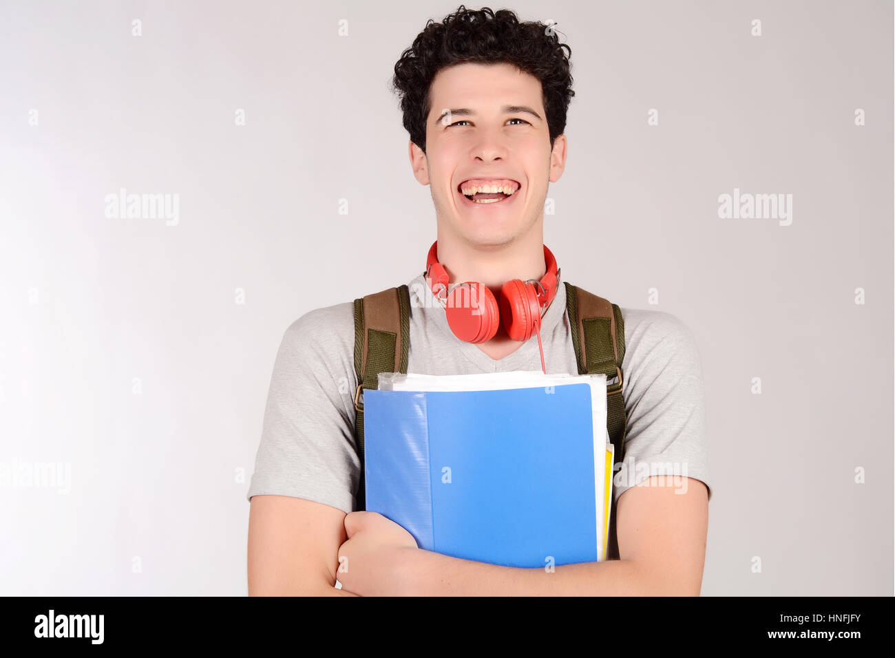 Portrait of young student holding notebook. Isolated white background ...