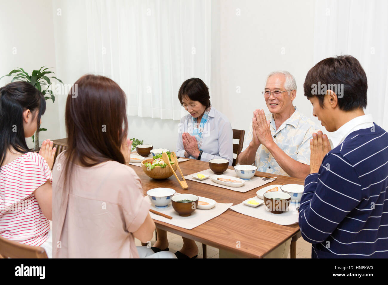 Three generation family at a dining table Stock Photo - Alamy