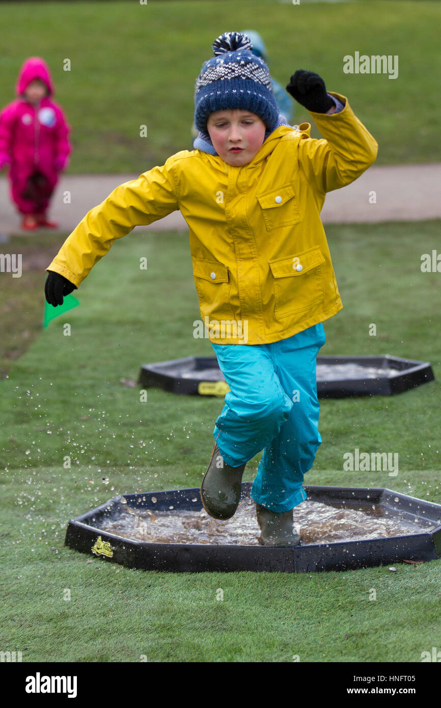 Children splashing in muddy puddles hi-res stock photography and images ...