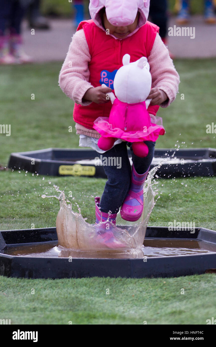Kid child jumping puddle water splash hi-res stock photography and ...