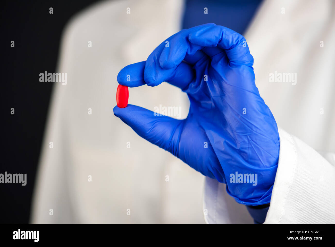 Female doctor offering red tablet pill, unrecognizable medical ...