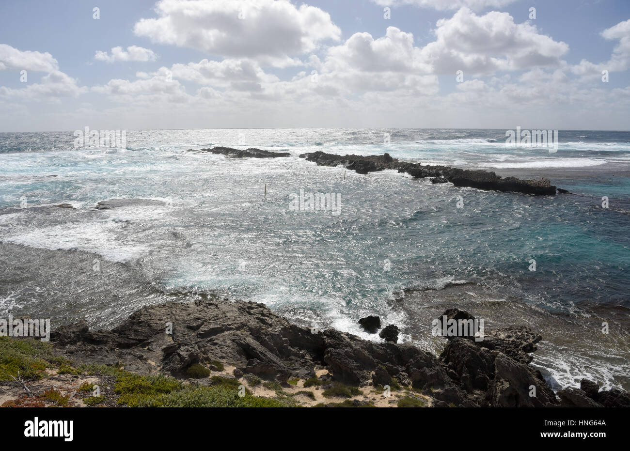 Glistening Indian Ocean seascape with eroded limestone rock at ...