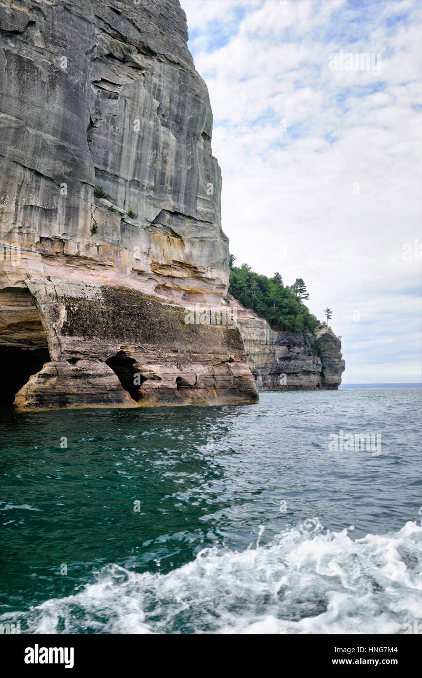 Tree-topped rocky cliffs and blue lake waters in a cove at scenic ...