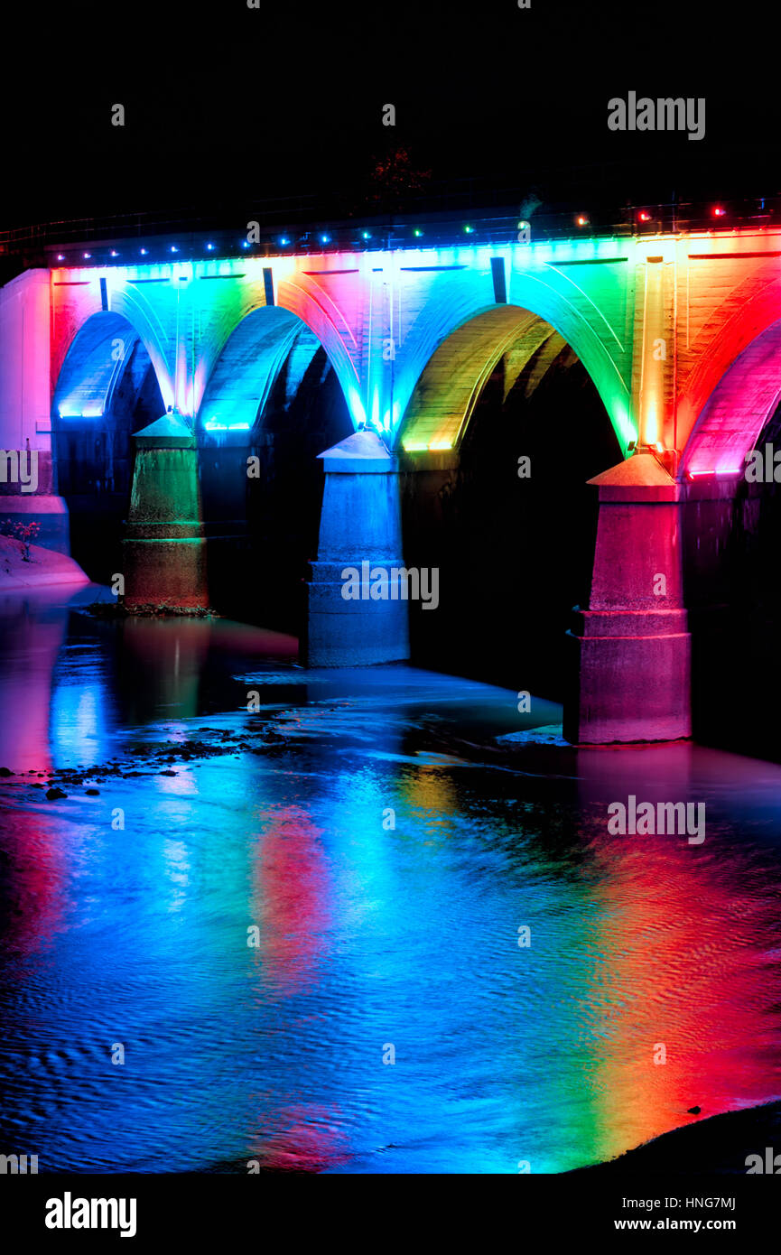 Rainbow bridge illuminated and glowing by colored LED lights and ...