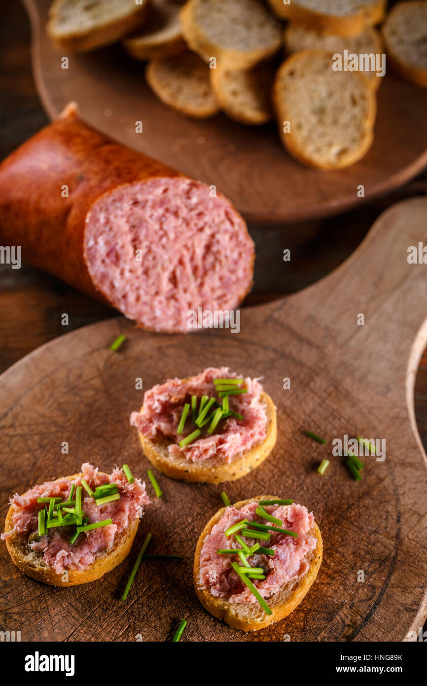 Savory smoked German teewurst on a slice of bruschetta topped with ...