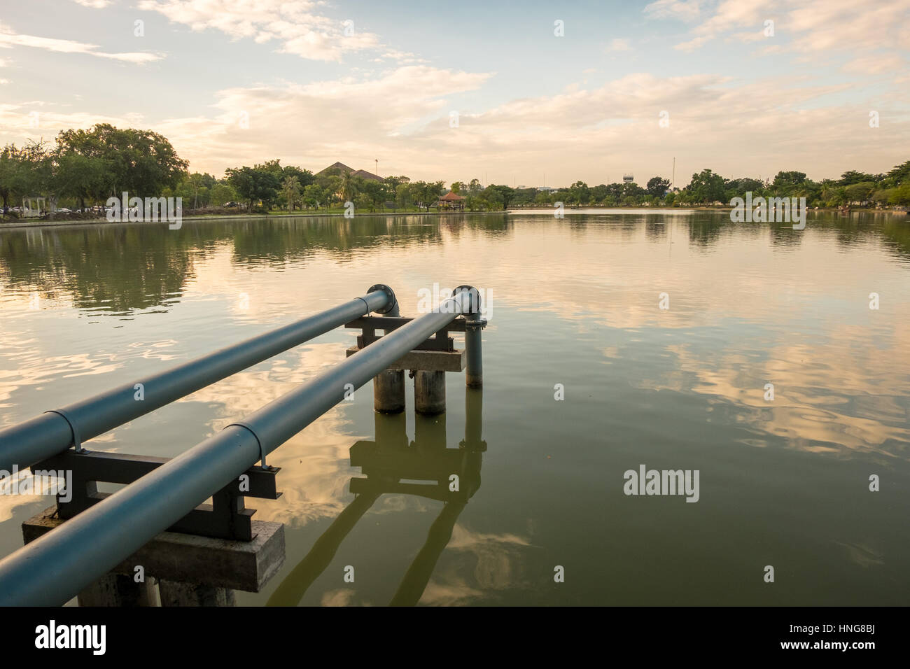 Steel pipe connect from pump into the lake within public park Stock ...
