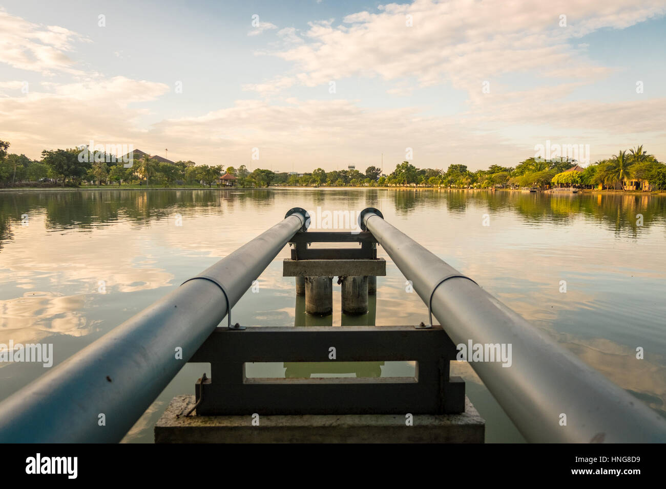 Steel pipe connect from pump into the lake within public park Stock ...