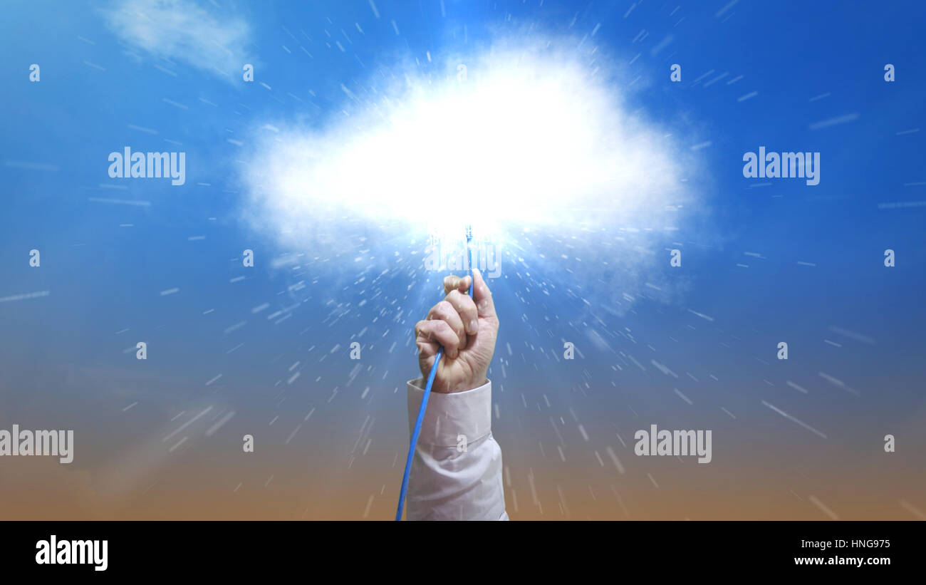 Hand plugging ethernet cable into a cloud illustrating concepts of ...
