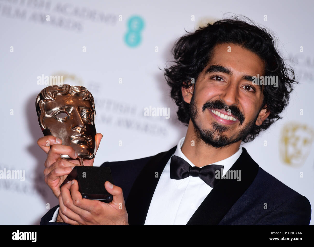 Dev Patel with his award for best Supporting Actor in the press room ...