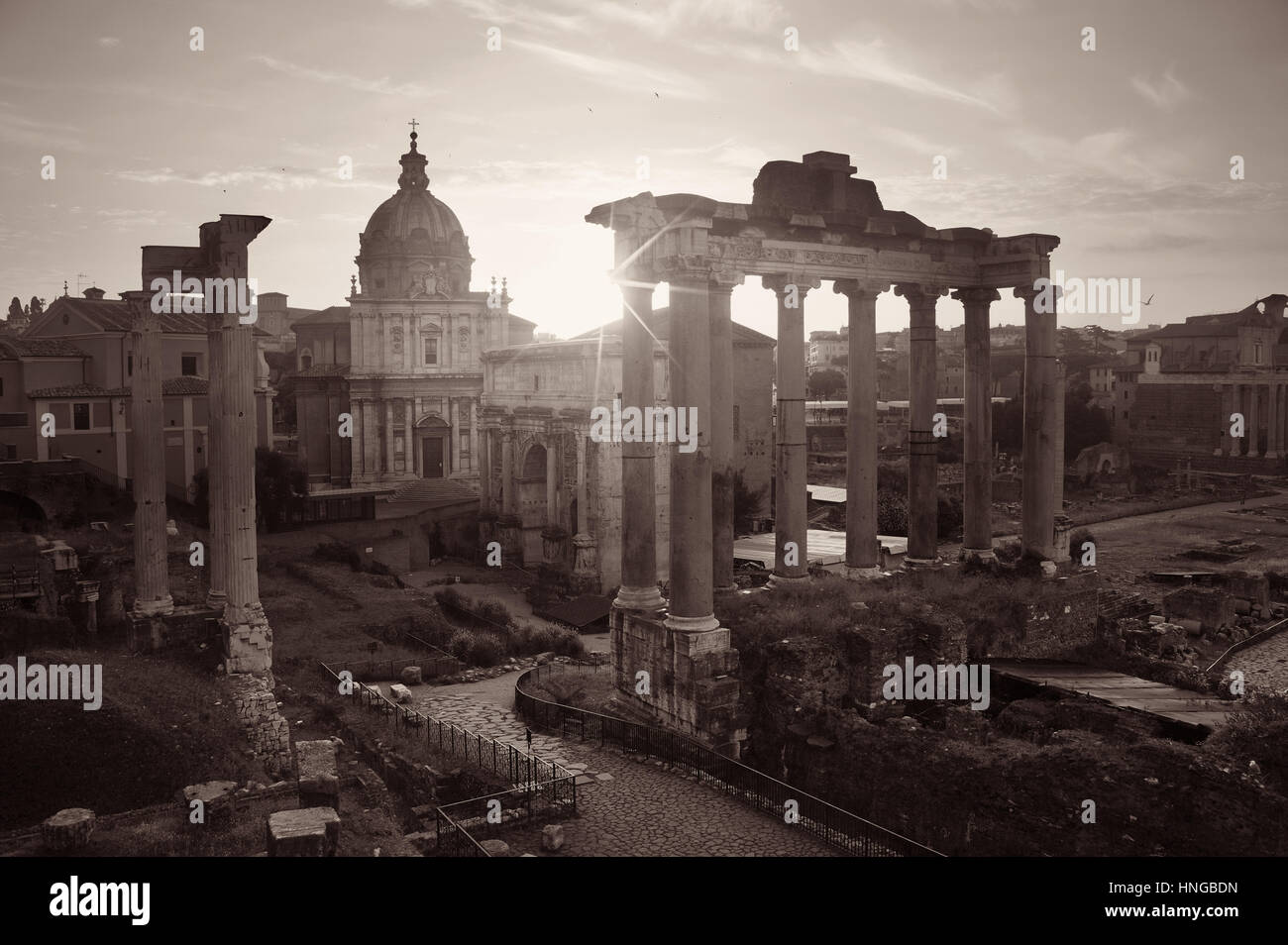 Rome Forum with ruins of ancient architecture at sunrise with sun ray ...