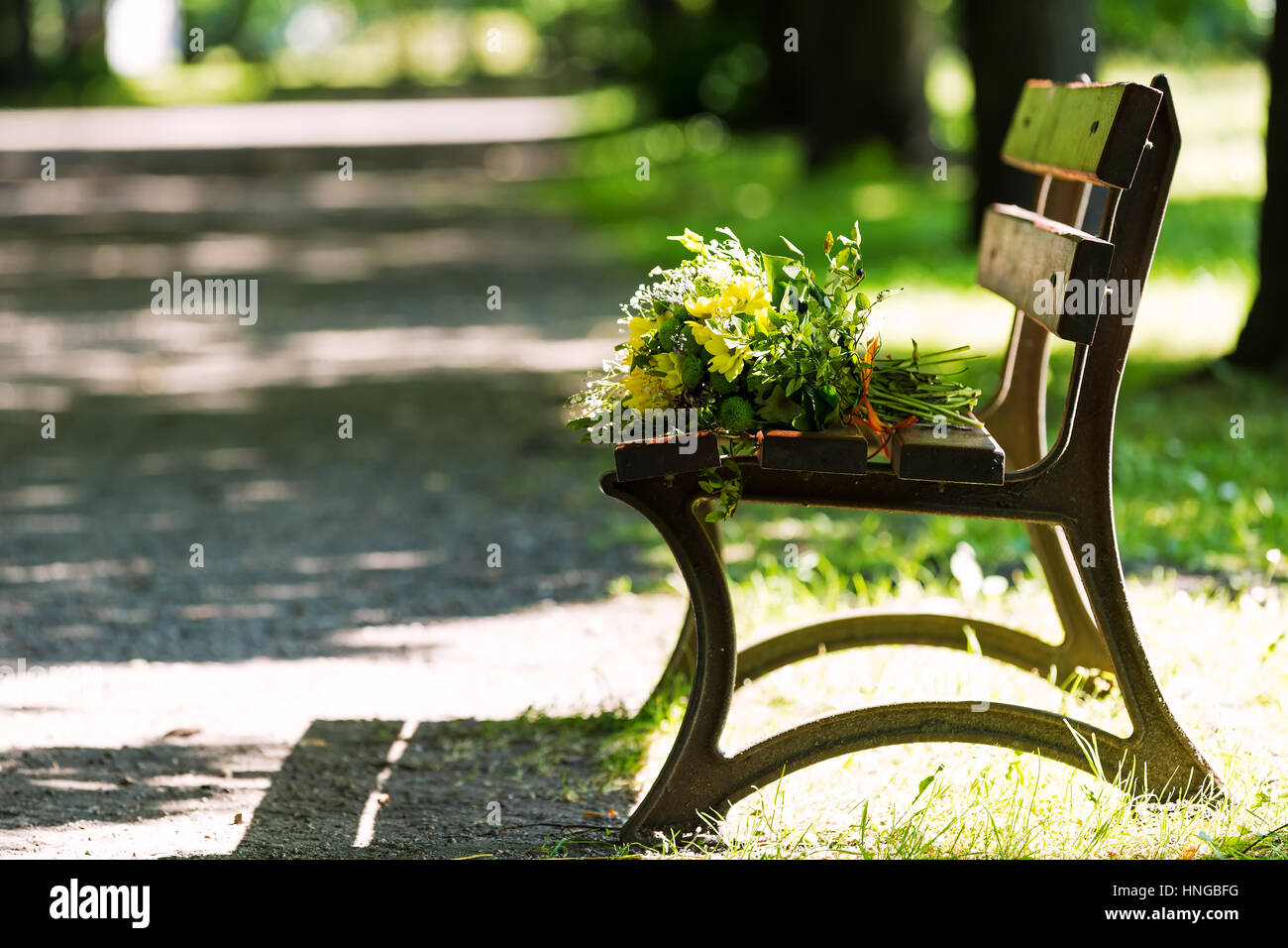 Bouquet of flowers on a park bench Stock Photo - Alamy