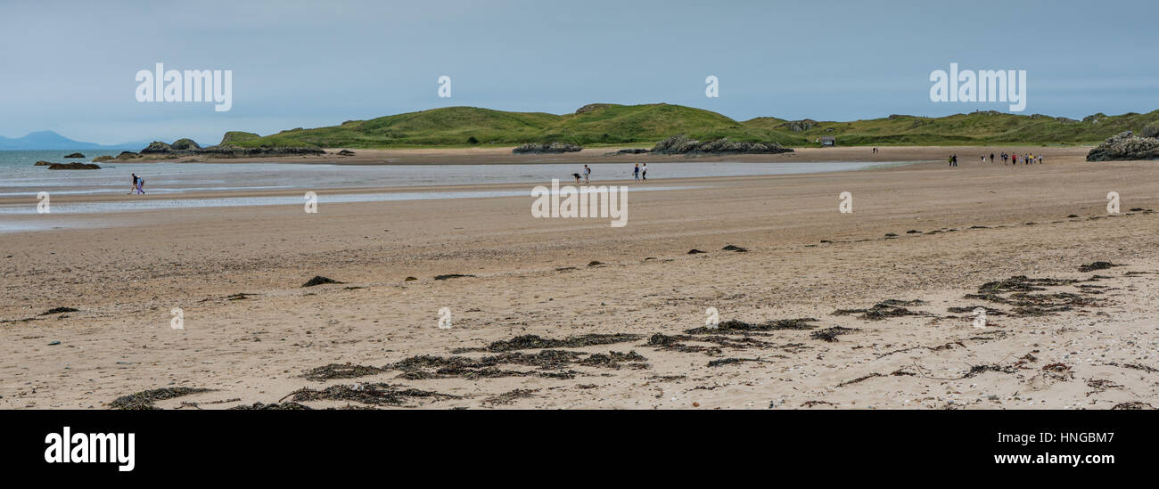 Panorama of people walking along Newborough Beach, Anglesey Stock Photo ...