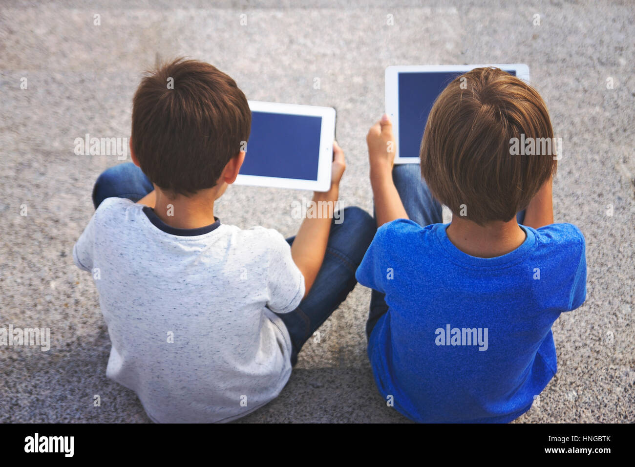 Children sitting with tablets computers. Back view. Education, learning ...