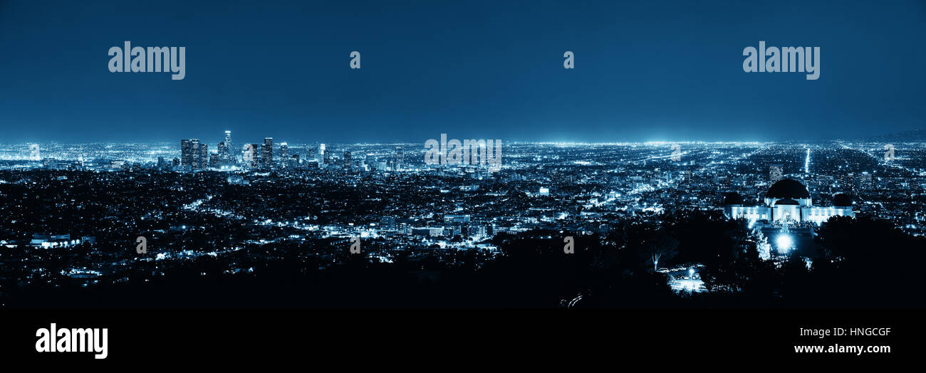 Los Angeles at night with urban buildings and Griffith Observatory ...