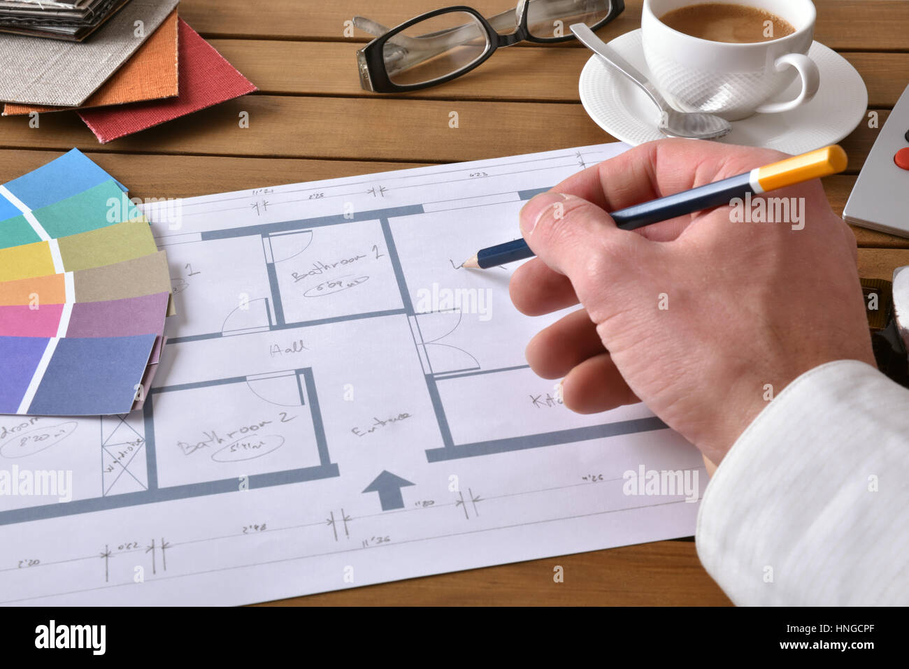 Designer working on an interior design project on wood table with a ...