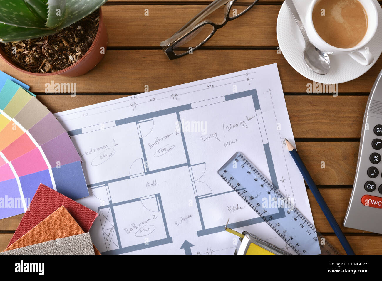 Wood table with a house plan, tools and samples of a decorator designer ...
