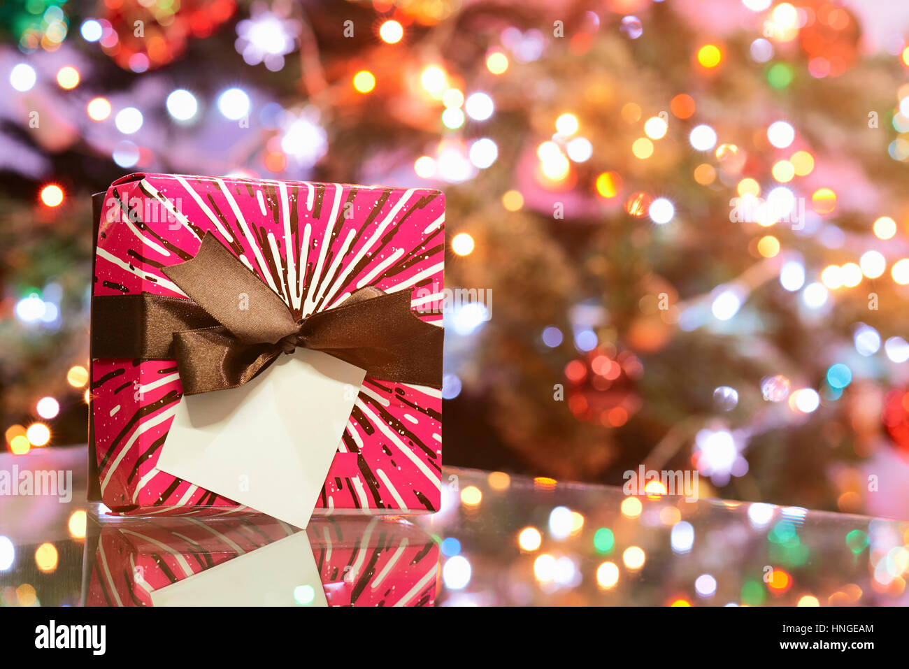 New year present colorful box lay on glass table in blurred light ...