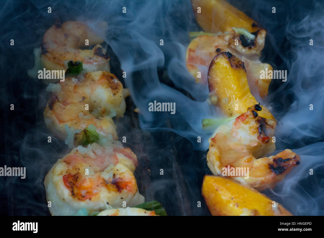 two skewers on grill cooking with smoke Stock Photo - Alamy