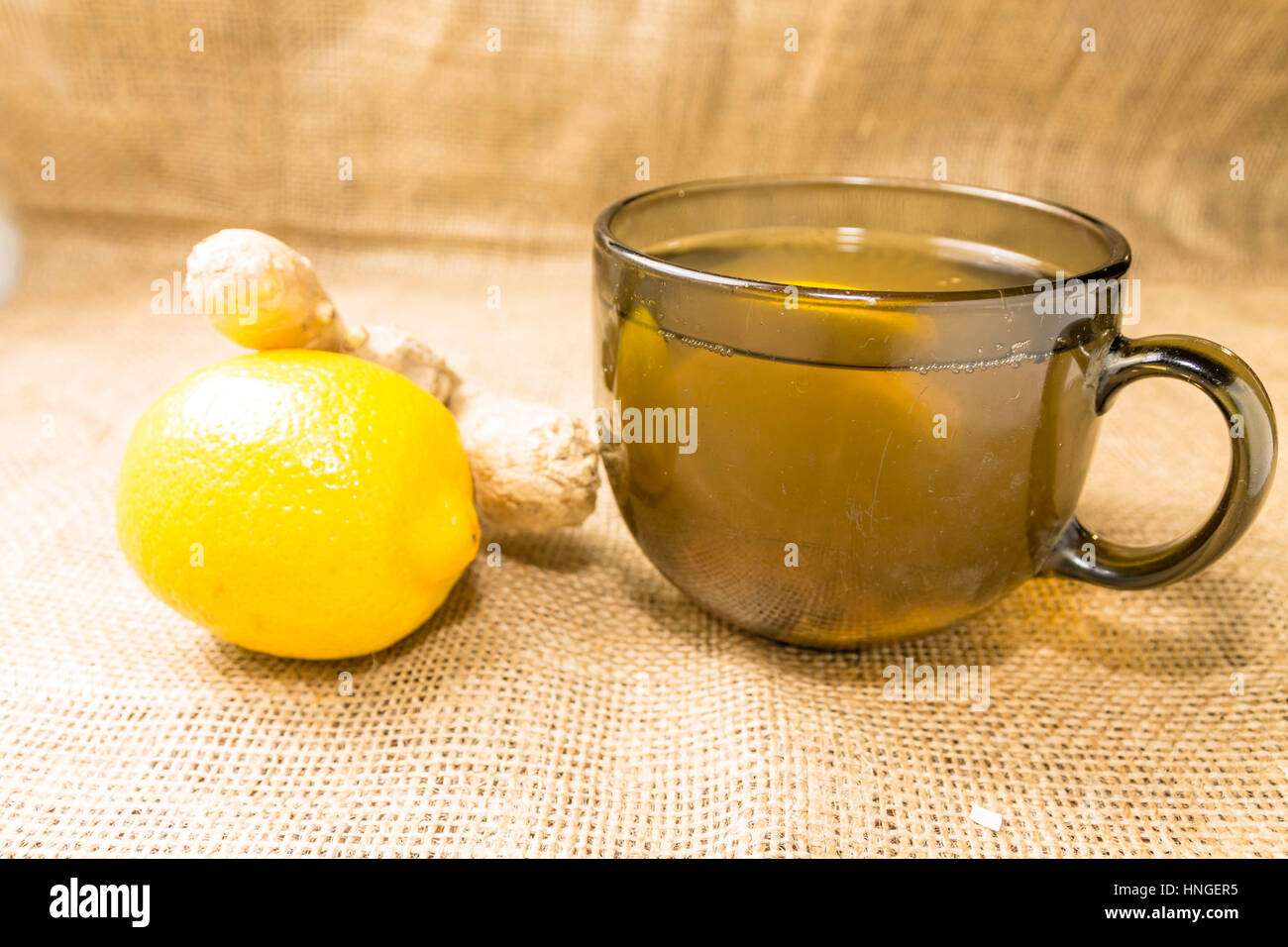 Tea with no sliced lemon and ginger root Stock Photo - Alamy