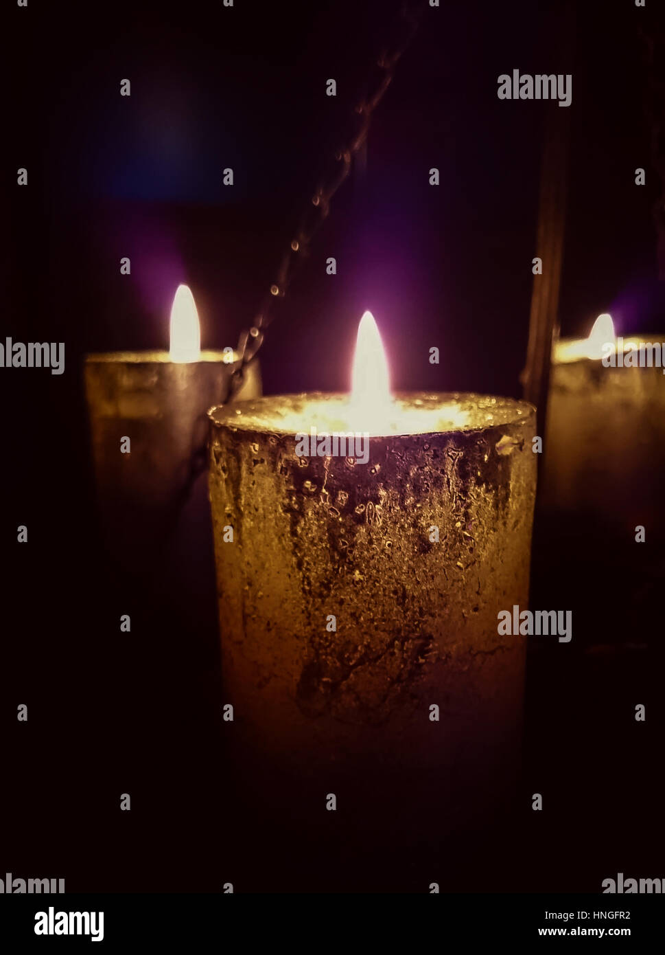 Magic candle light on chains at black Stock Photo - Alamy