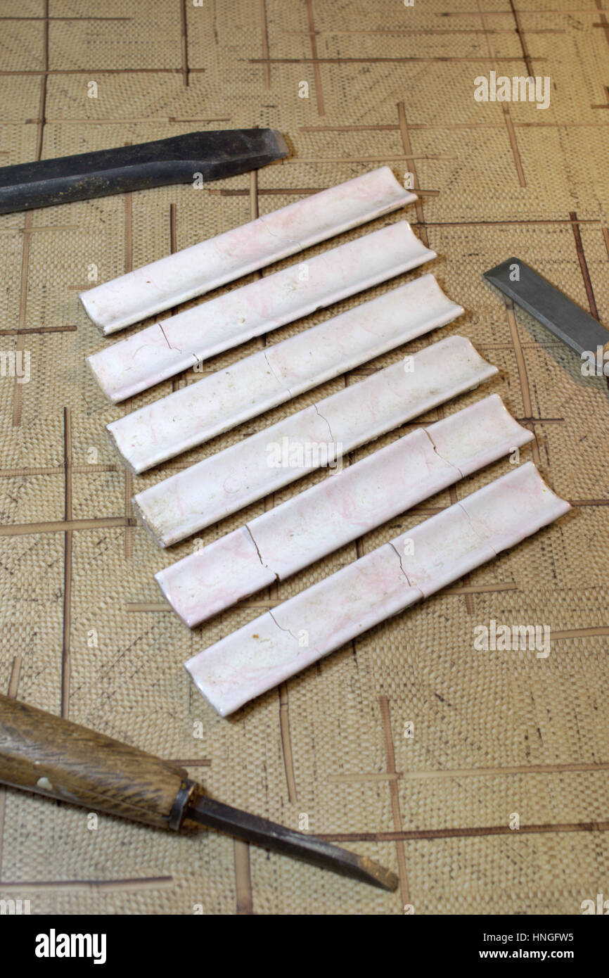 Broken skirting of ceramic tiles and chisels for dismantle Stock Photo ...