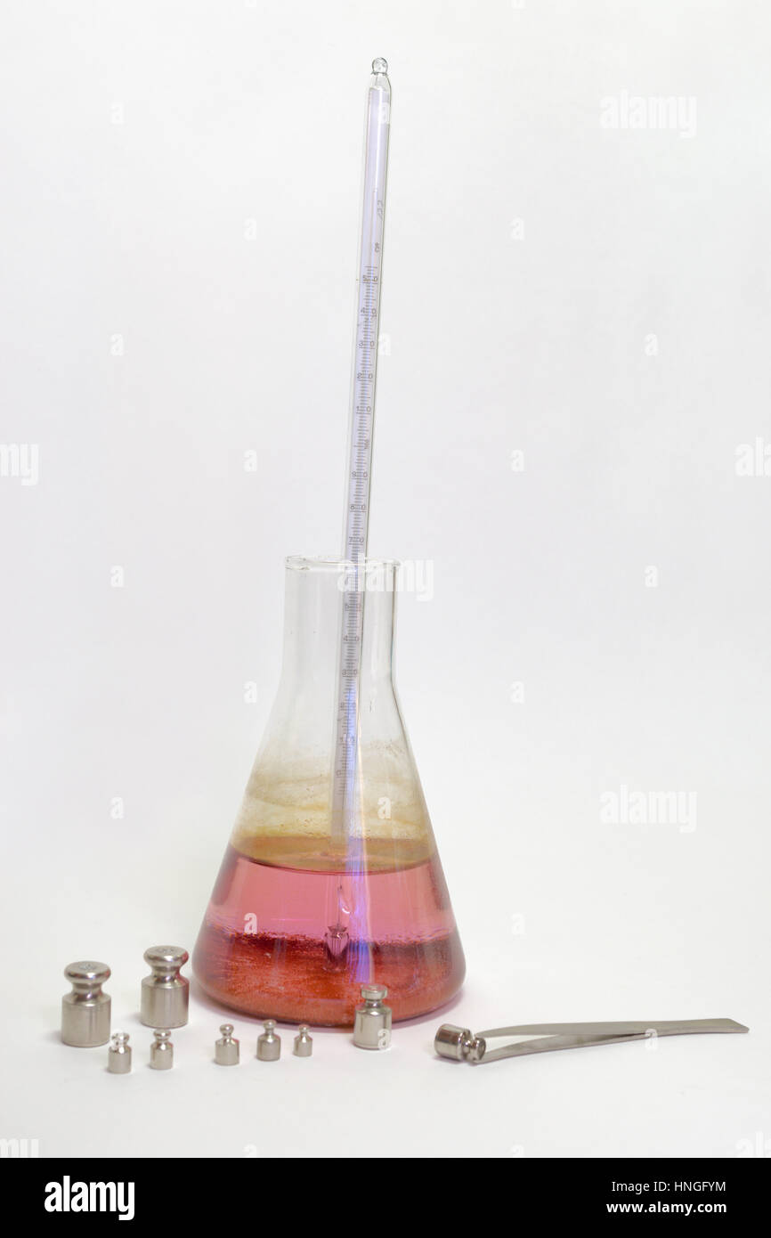 Glass Laboratory Flask With Thermometer Lowered Into Pink Solution