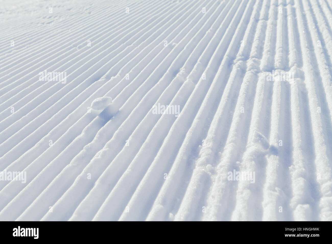 Snow lines made from a snow machine on a ski slope, texture Stock Photo ...