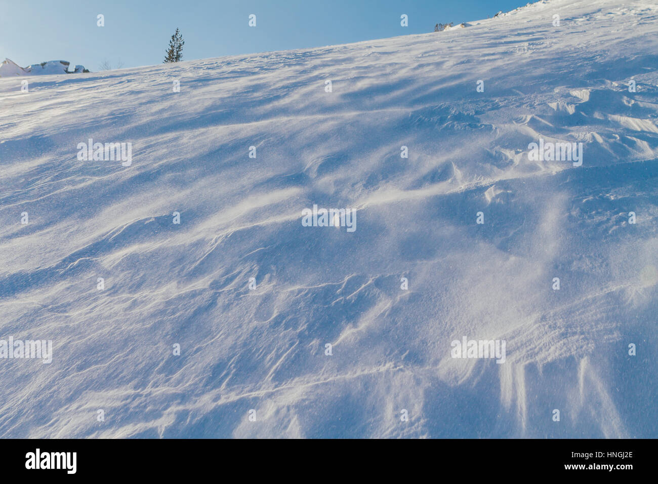 Windy snow slope in a sunny day Stock Photo - Alamy