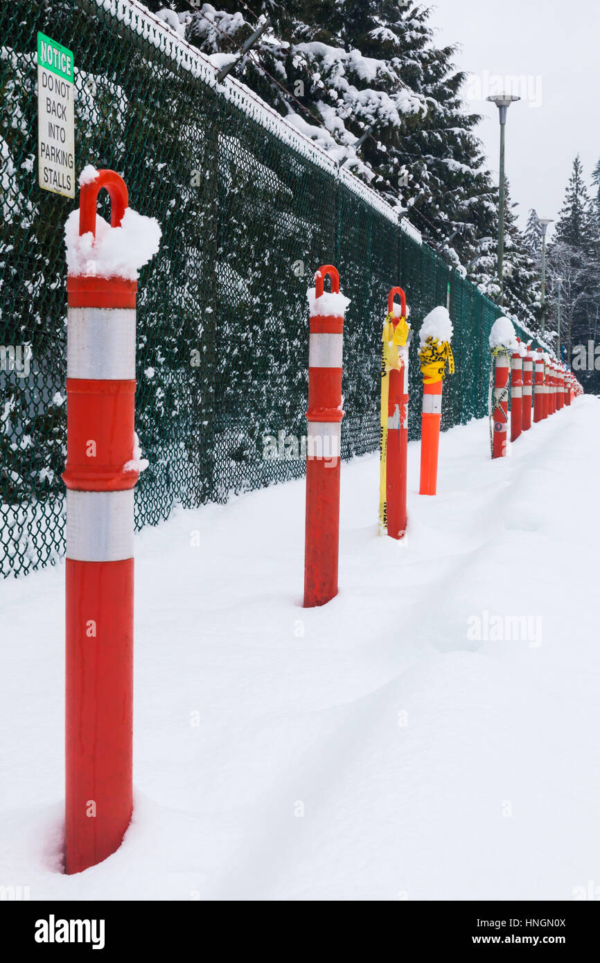 Red warning posts in a deserted parking lot with heavy snow Stock Photo ...