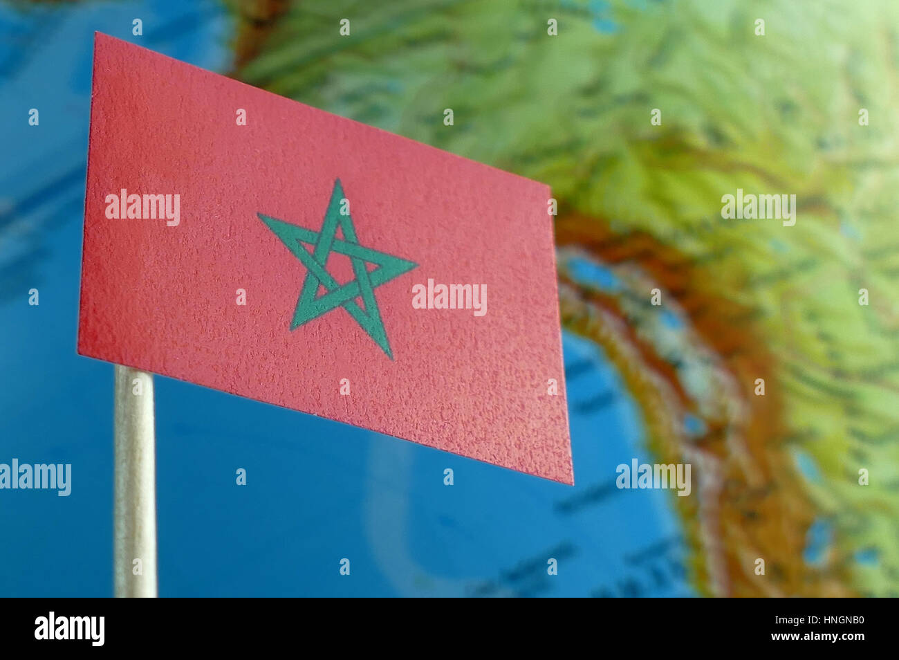 Morocco flag with a globe map as a background macro Stock Photo - Alamy