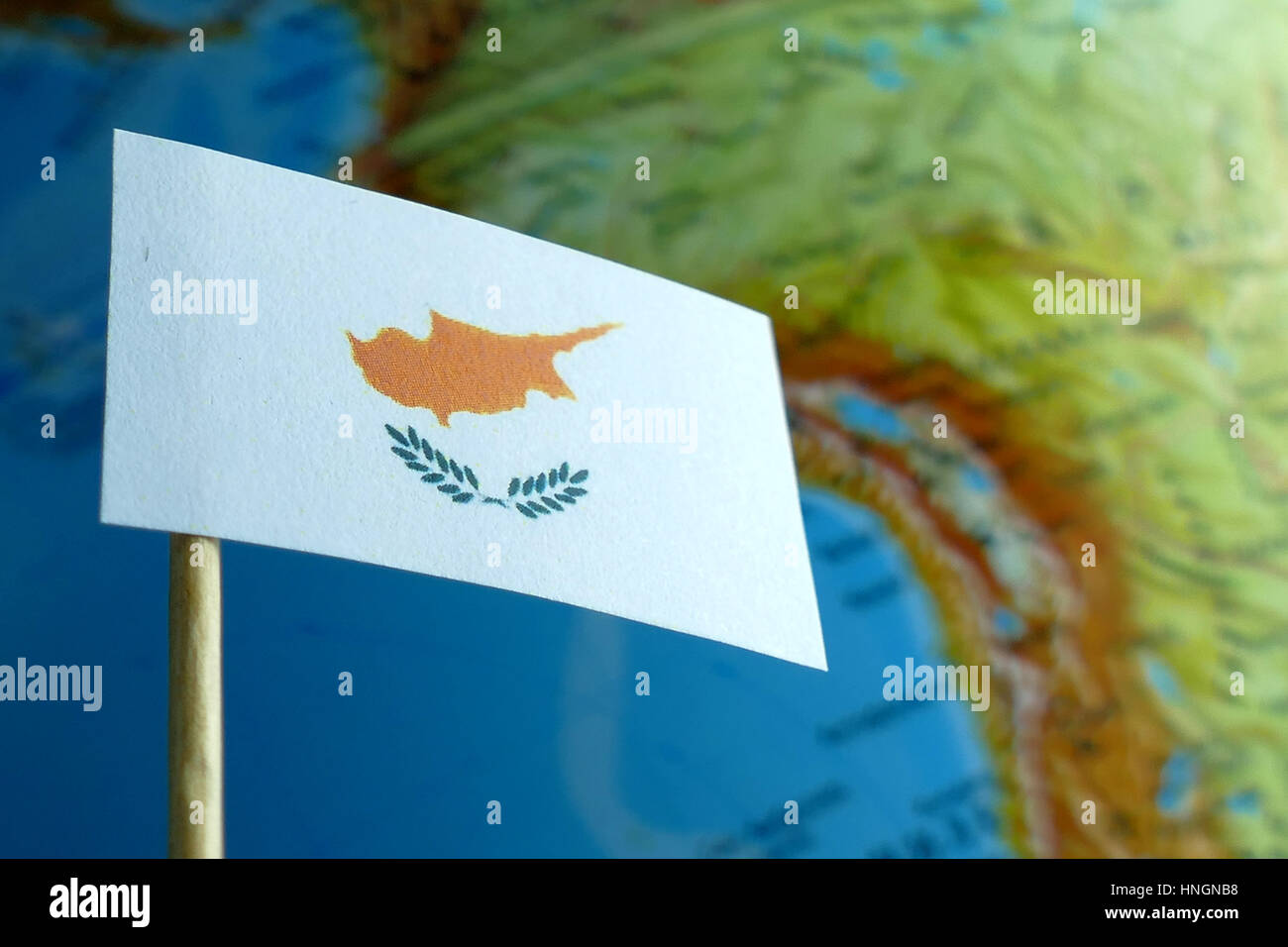 Cyprus flag with a globe map as a background macro Stock Photo - Alamy