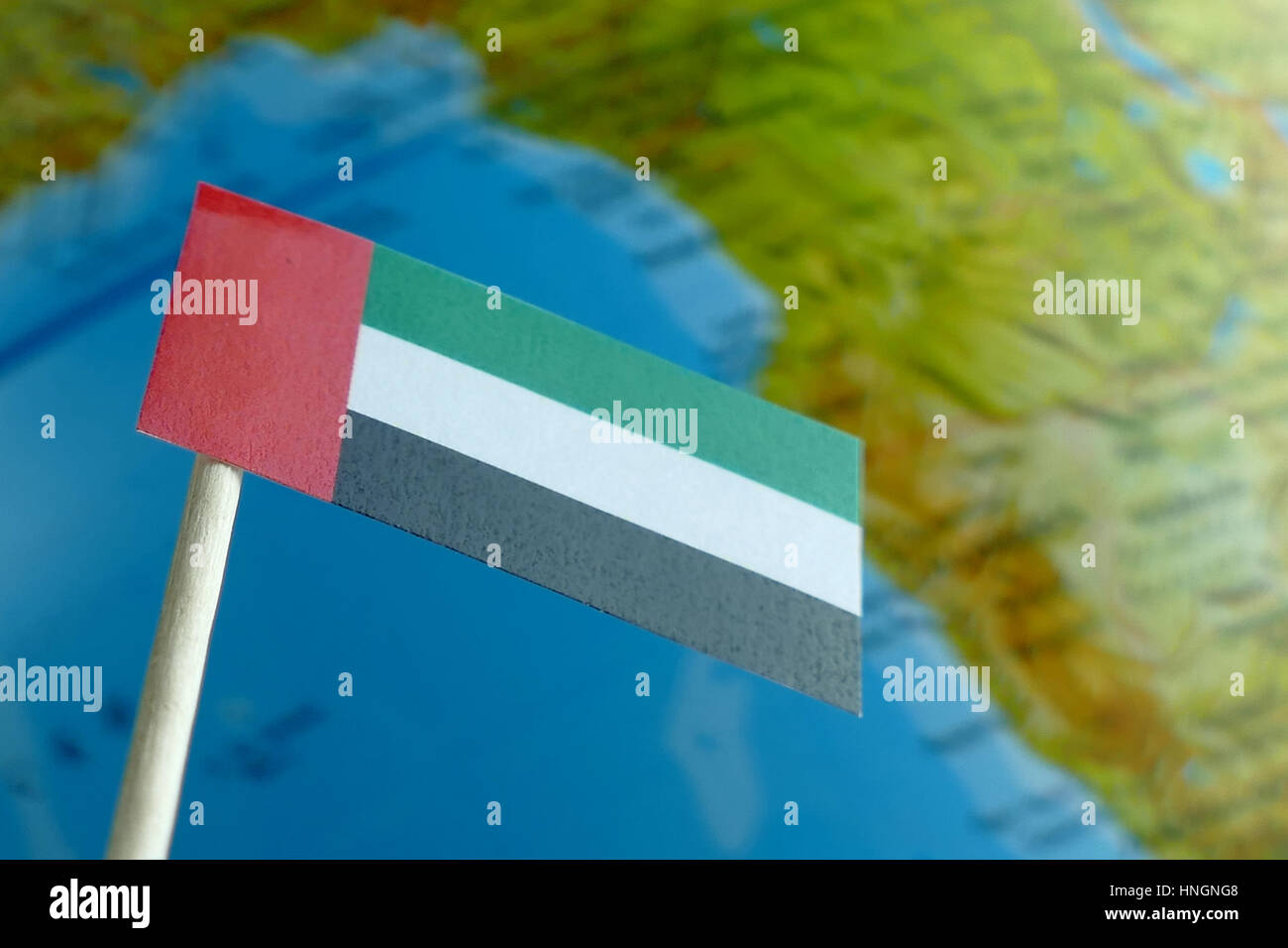 United Arab Emirates flag with a globe map as a background macro Stock ...