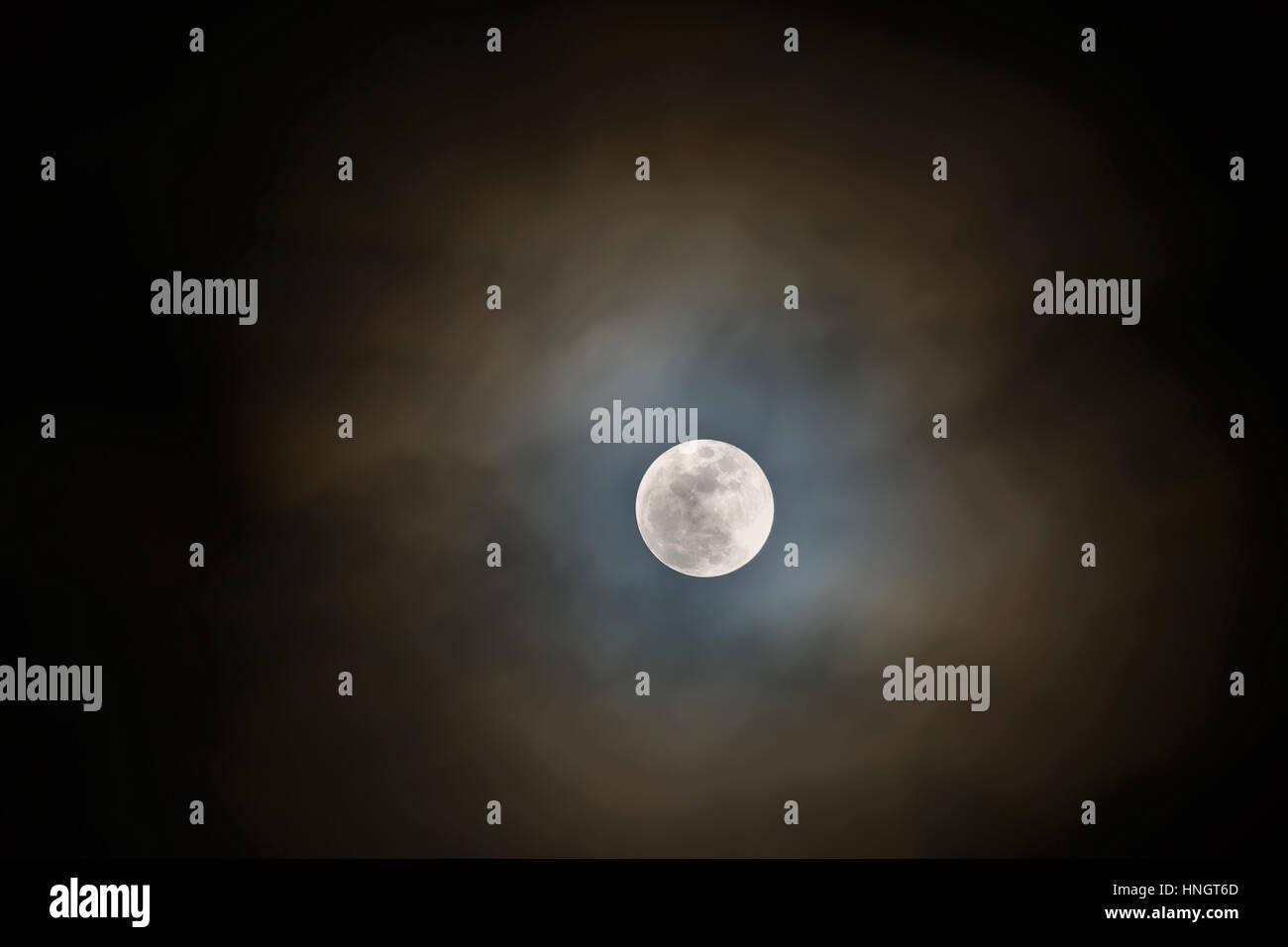 Snow Moon Full Moon Rising with Storm Clouds Stock Photo - Alamy