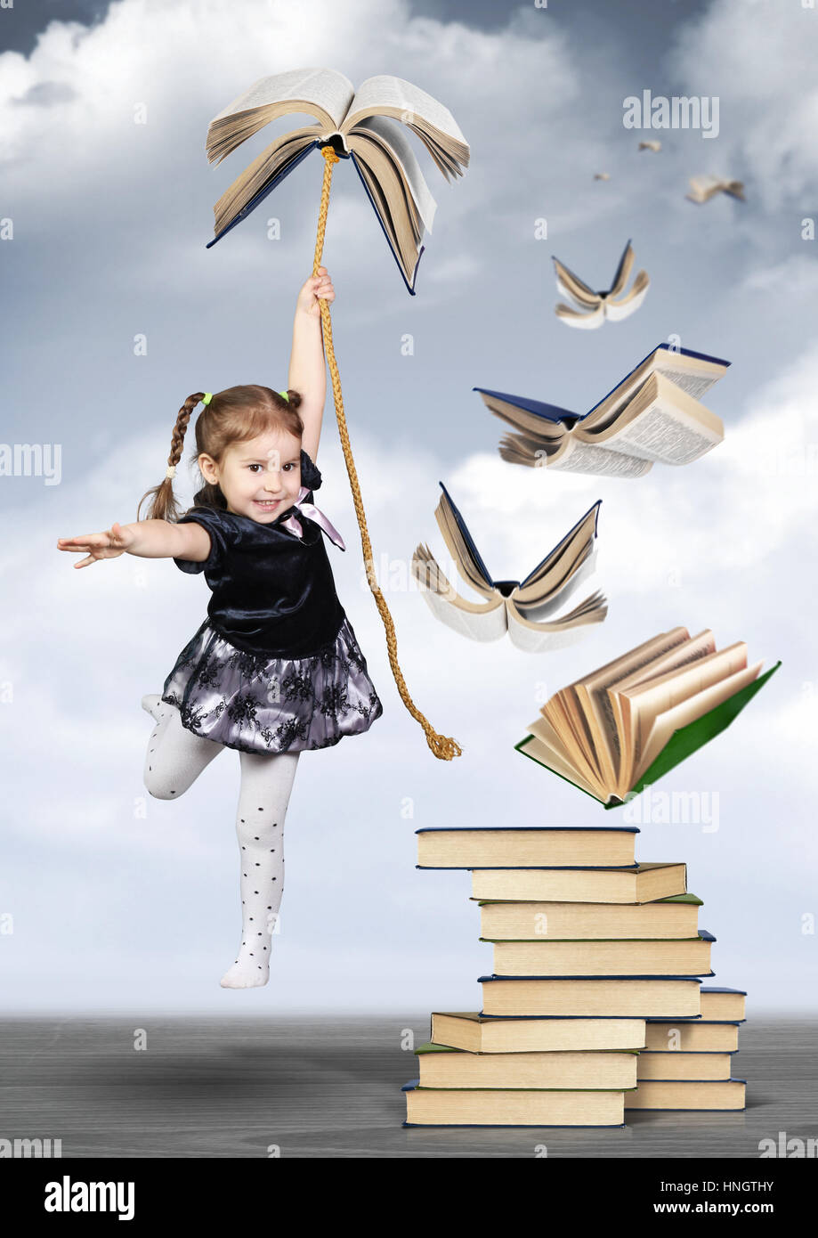 Education concept , child girl fly on book Stock Photo - Alamy