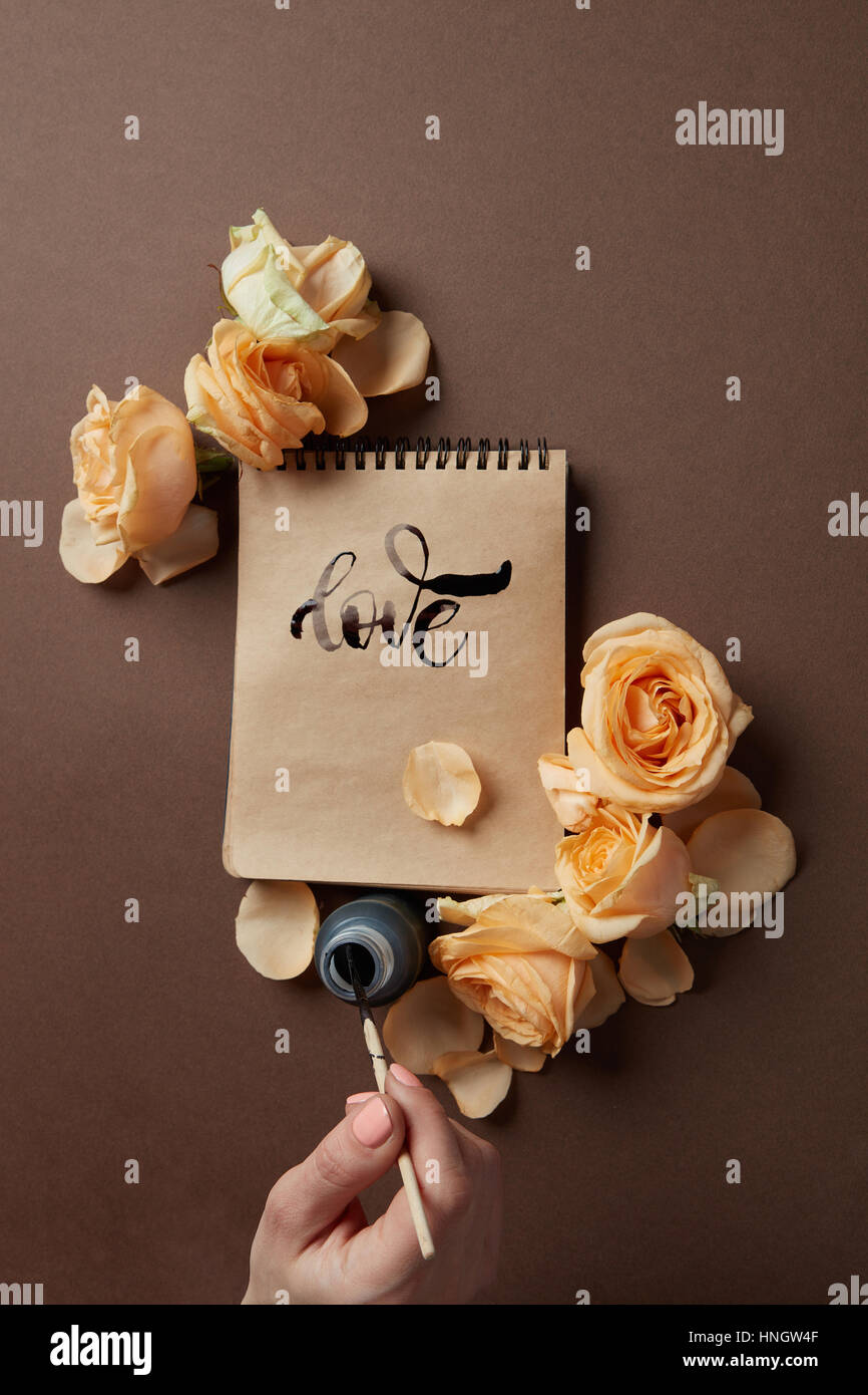 Female hands writing down on letter paper for Valentine's day with ...