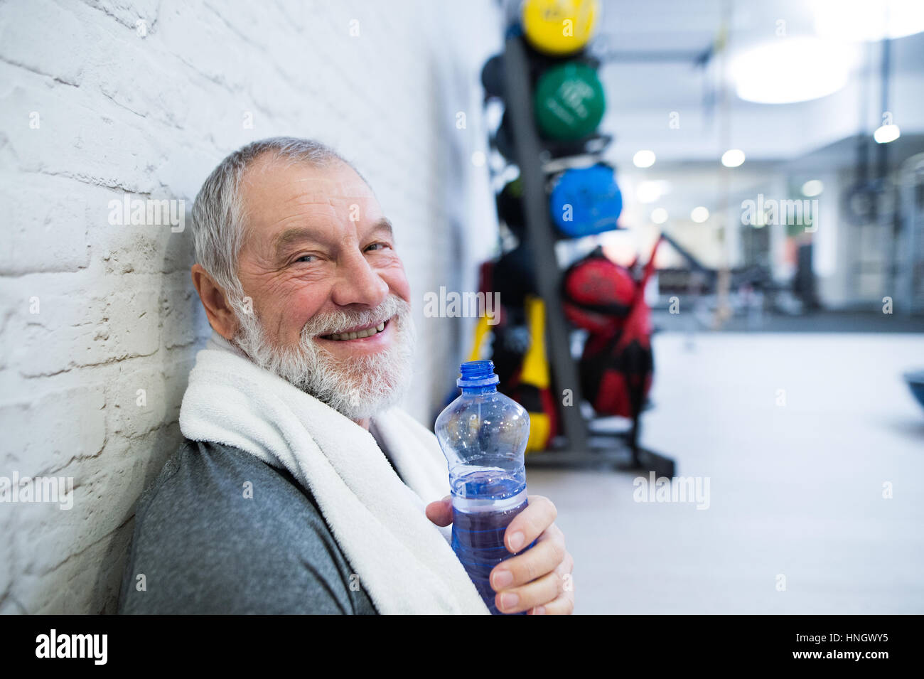 Fit senior man in gym resting after working out Stock Photo - Alamy