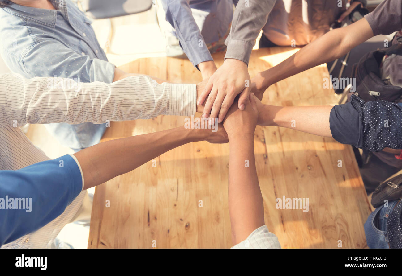 people putting their hands together for united, cooperation and ...