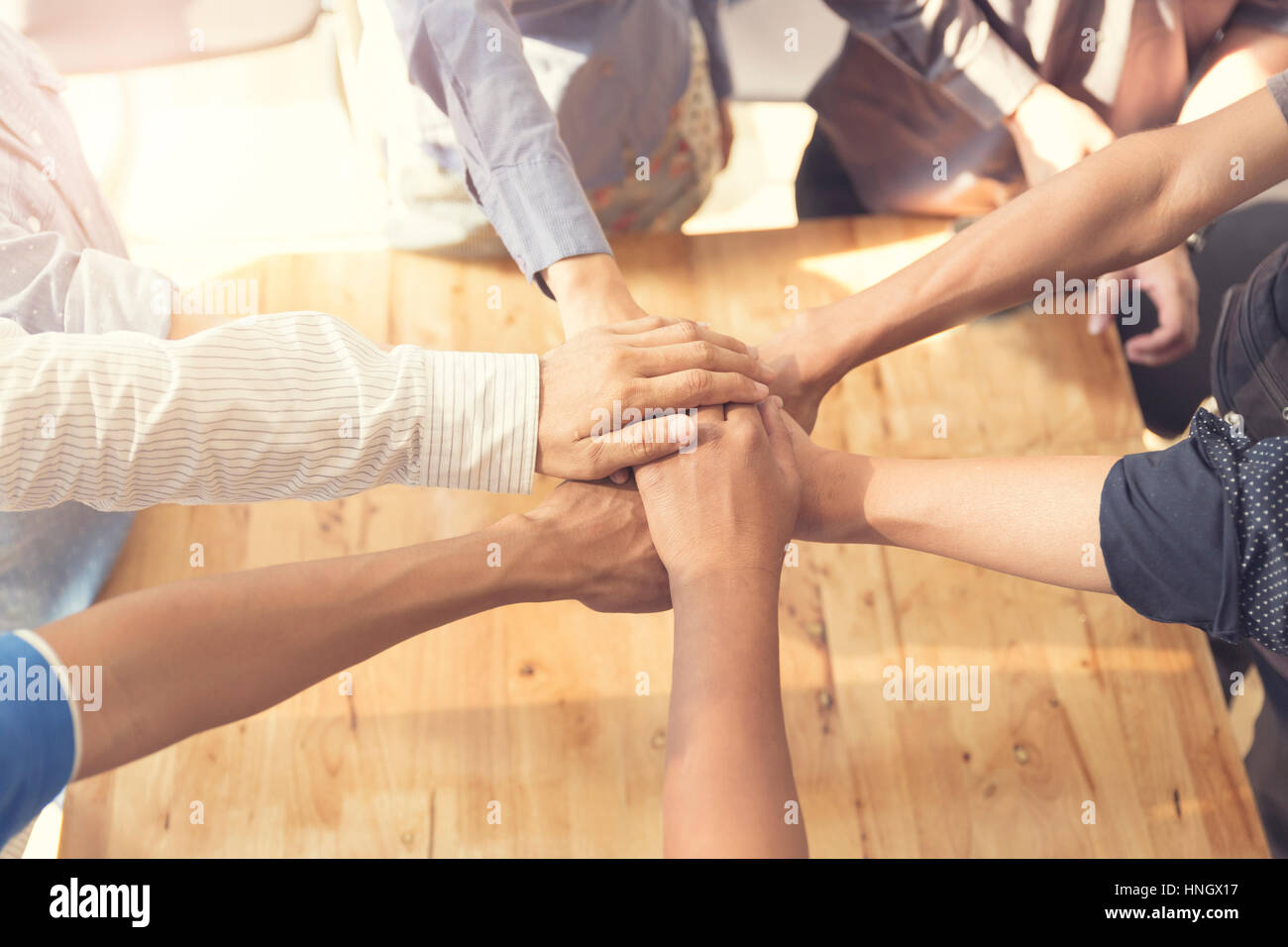 people putting their hands together for united, cooperation and ...