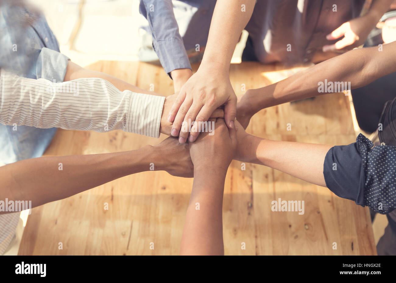 people putting their hands together for united, cooperation and ...