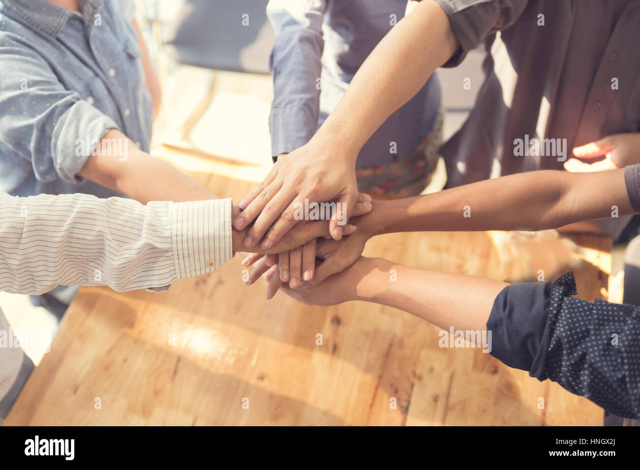 people putting their hands together for united, cooperation and ...