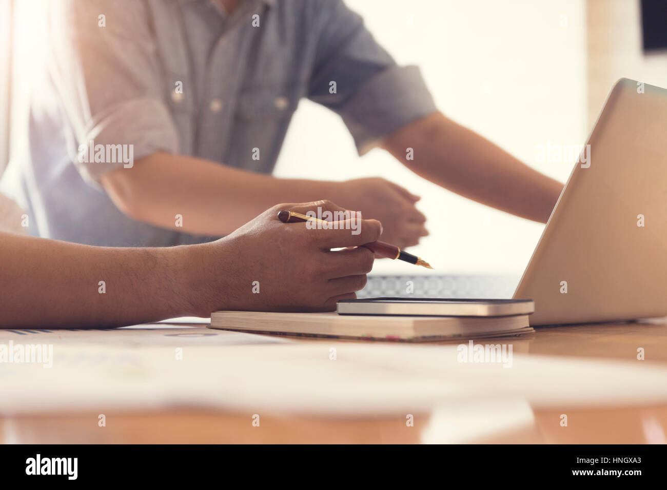 people working with laptop computer notebook and business document ...